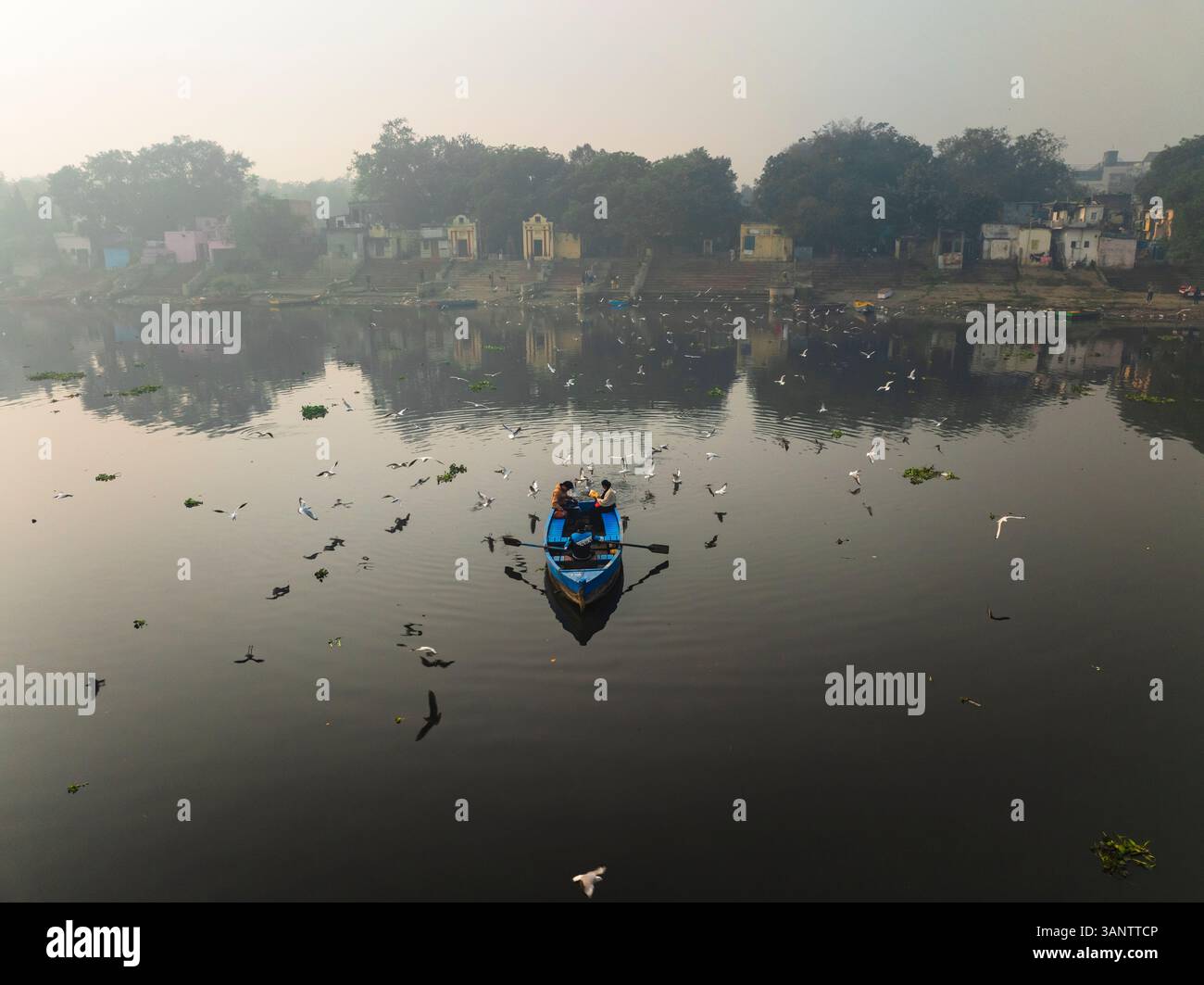 Aerial view of tranquil Yamuna Ghat with boats and birds on the Yamuna ...