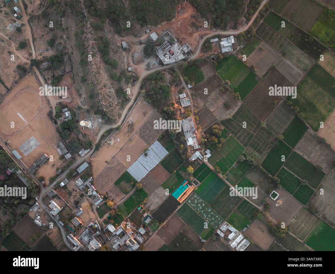 Aerial view of patchwork farmland and rural village with buildings and ...