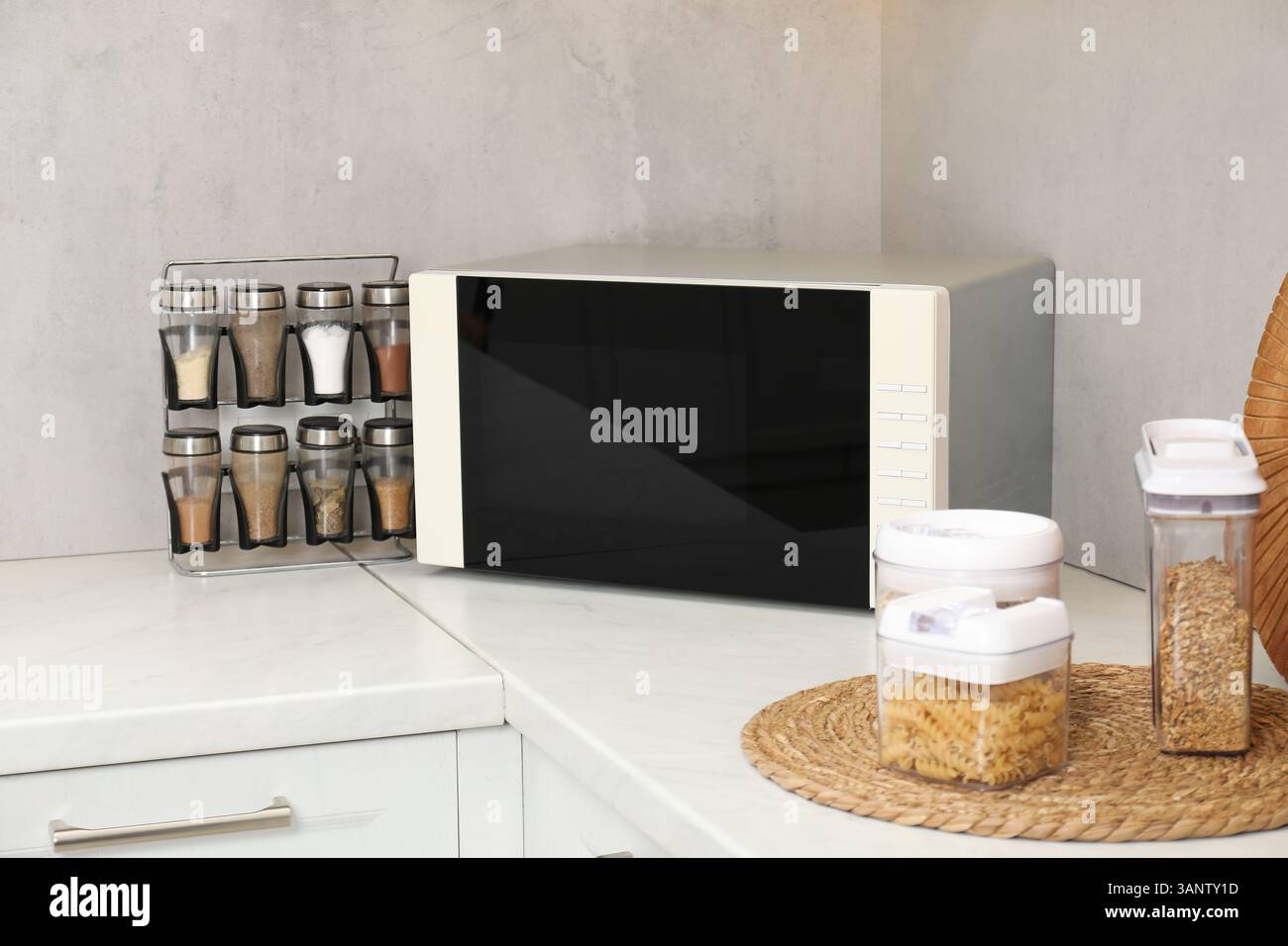 Closed microwave oven on counter in kitchen Stock Photo - Alamy