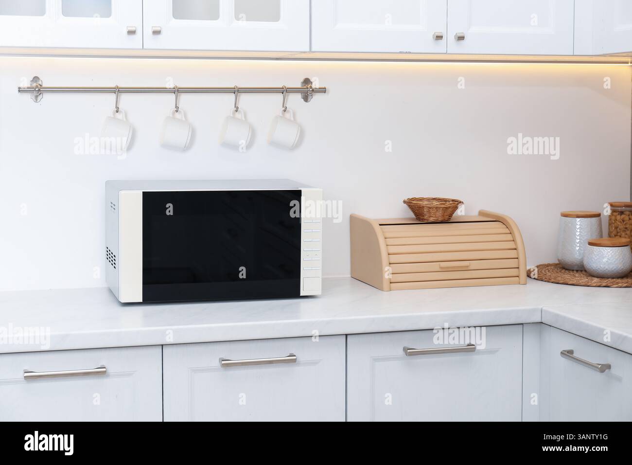 Closed microwave oven on counter in kitchen Stock Photo - Alamy