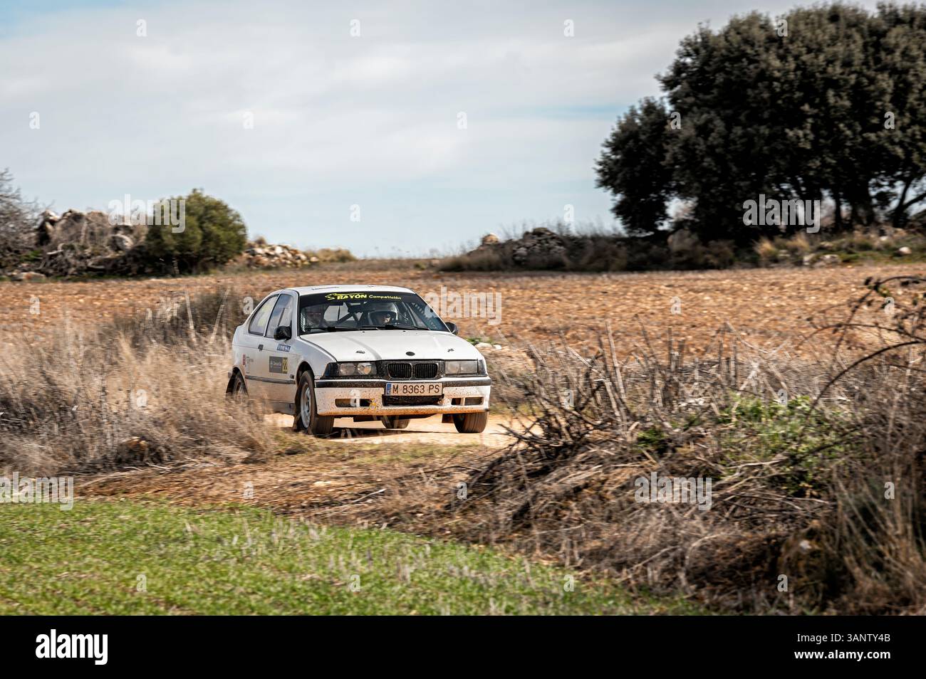 Madrid, Spain; 02-15-2025: A white BMW 316i E36 powers through a rugged ...
