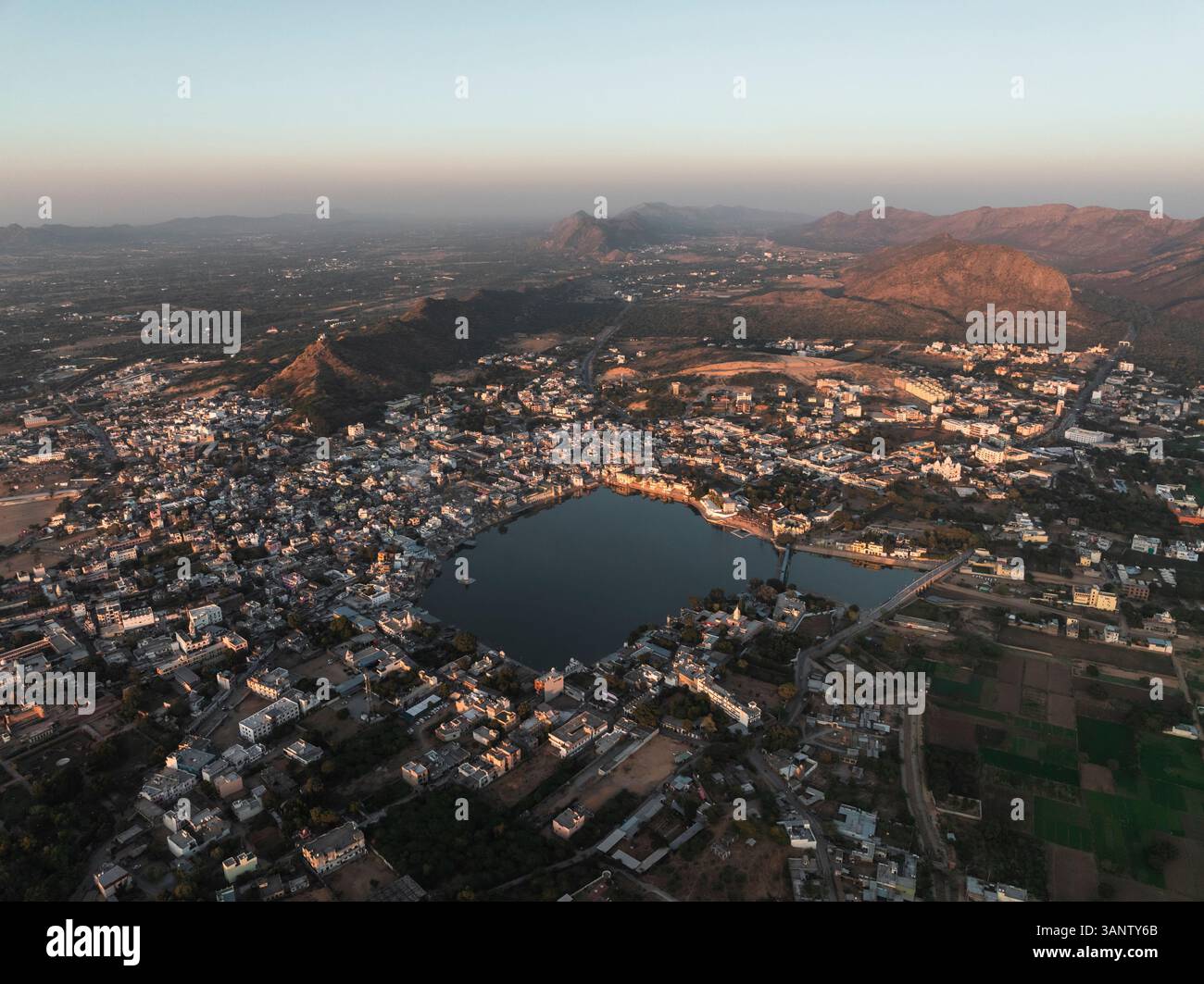 Aerial view of Pushkar Lake with scenic ghat and picturesque mountains ...