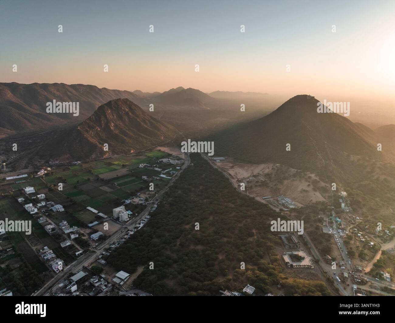Aerial view of serene sunset over picturesque mountains and valley with ...
