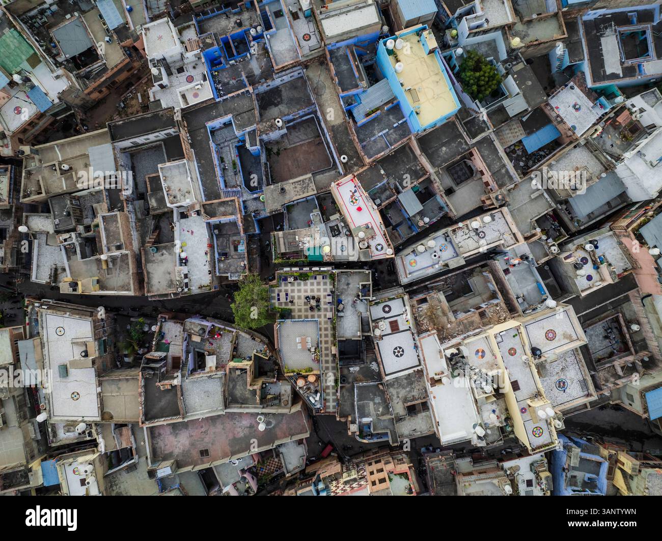 Aerial view of vibrant and colorful rooftops in a dense urban landscape ...