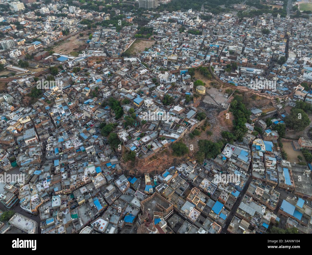 Aerial view of crowded urban landscape with blue roofs and dense ...