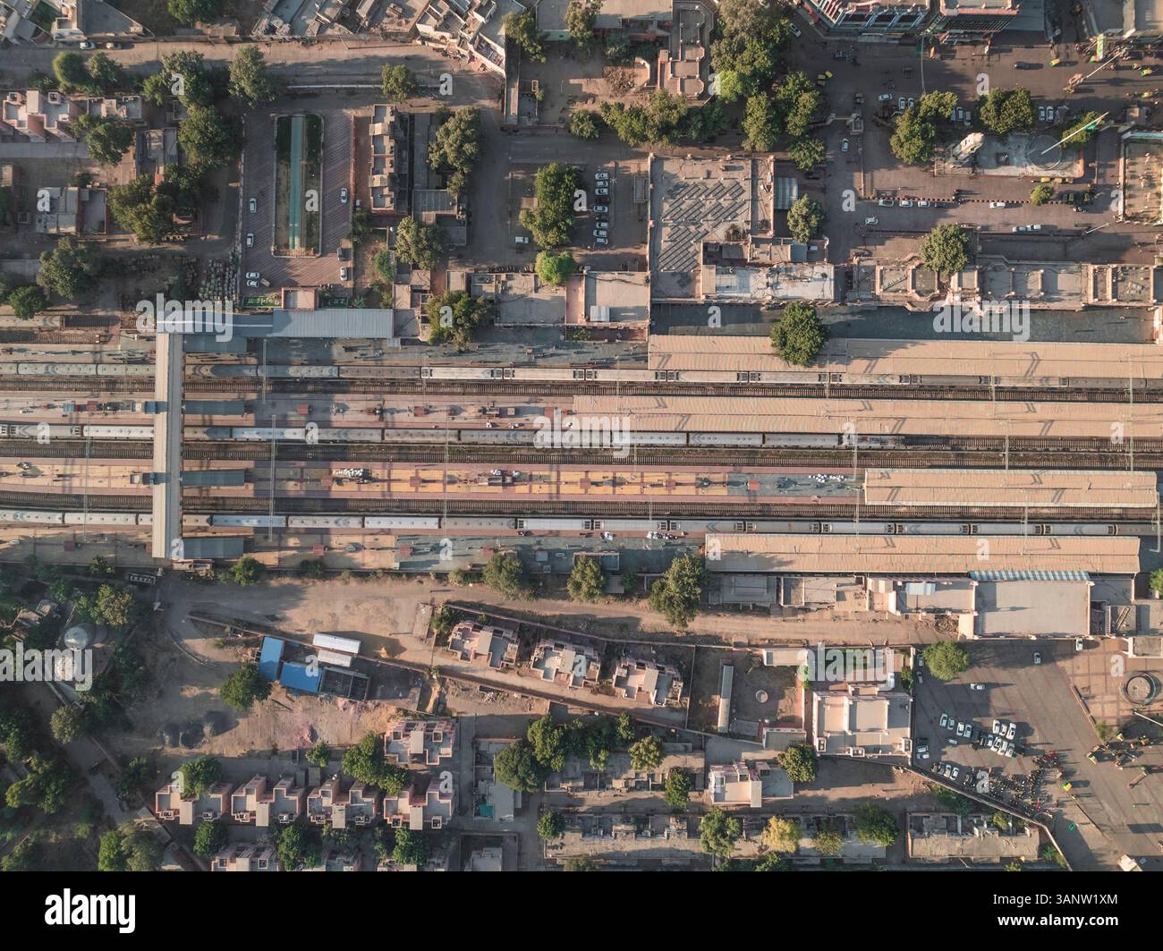Aerial view of railway station and train tracks surrounded by buildings ...