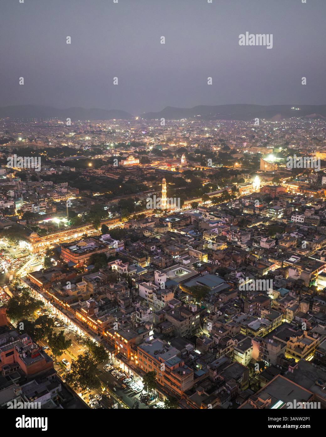 Aerial view of vibrant illuminated cityscape at twilight with bustling ...