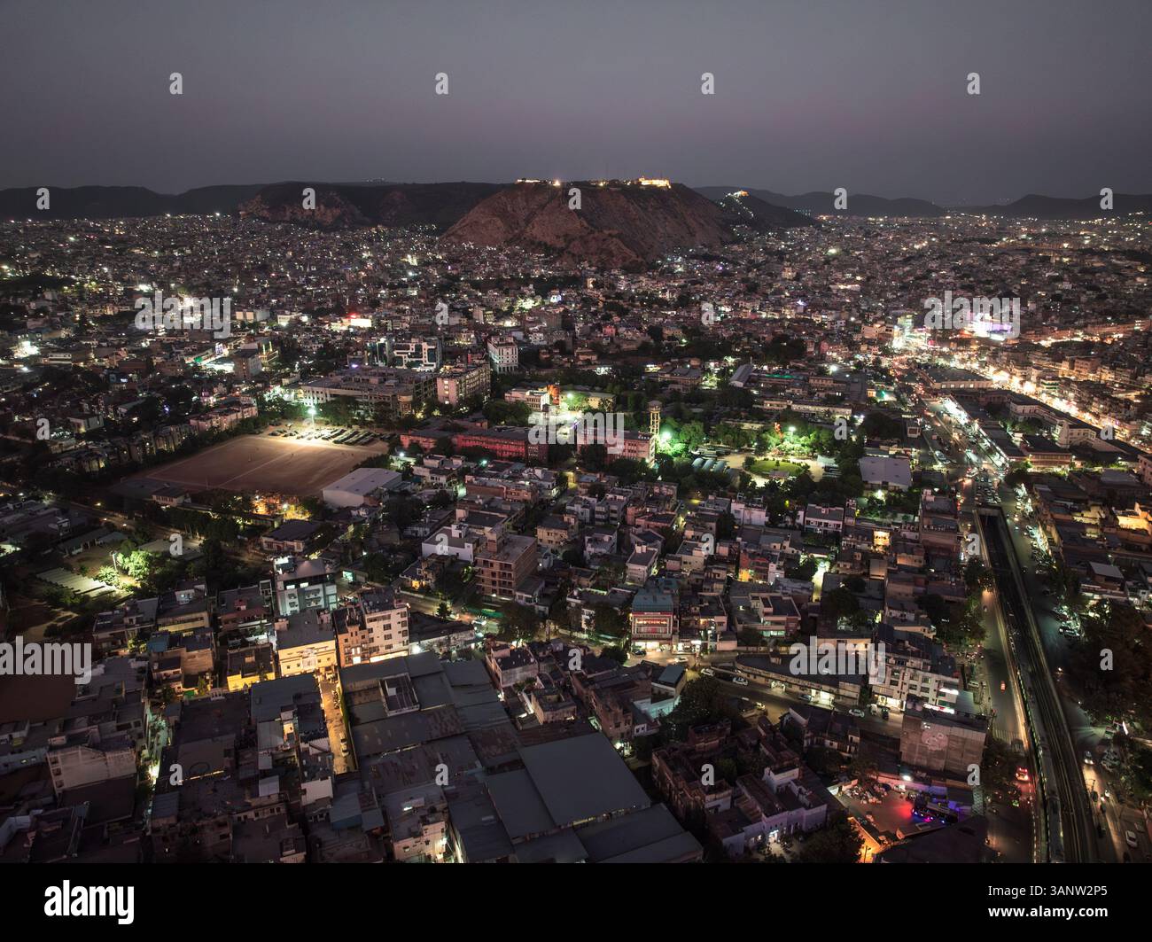 Aerial view of vibrant cityscape illuminated by city lights with ...