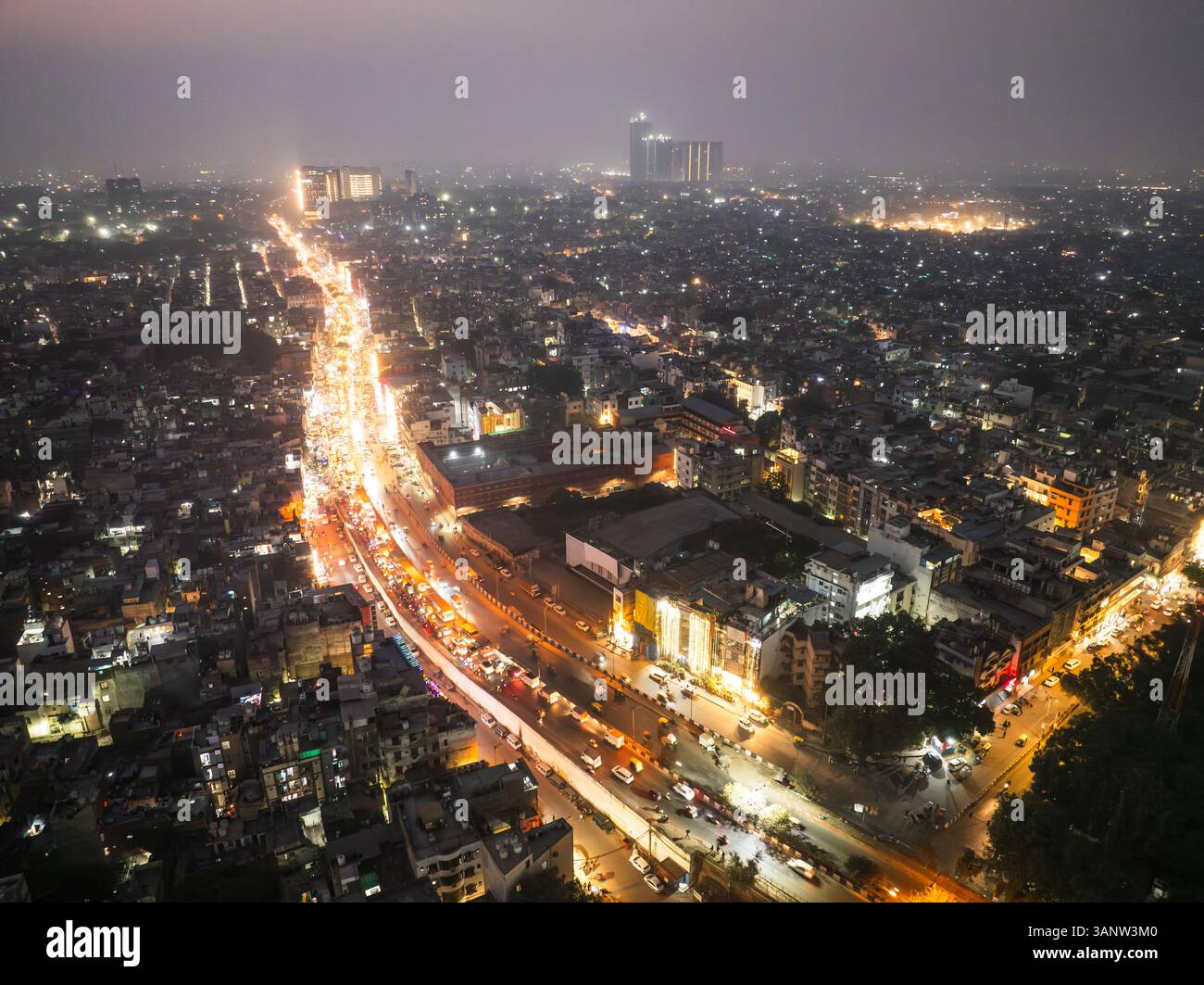 Aerial view of busy cityscape with vibrant lights and traffic at night ...