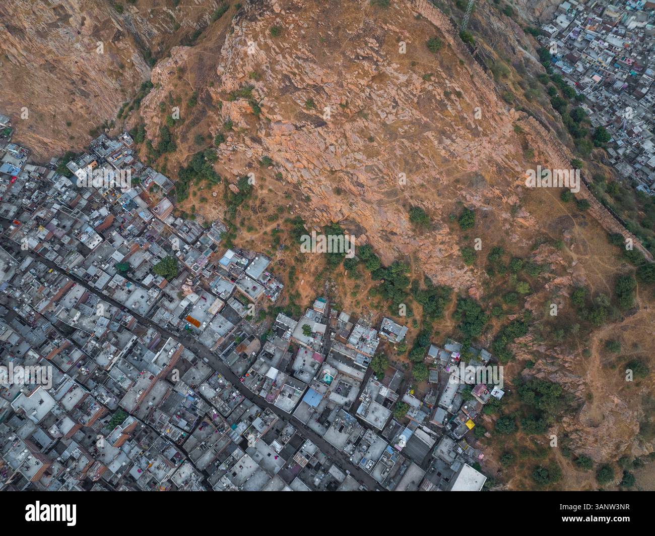 Aerial view of urban landscape with residential buildings and mountainous terrain, Nahari Ka ...