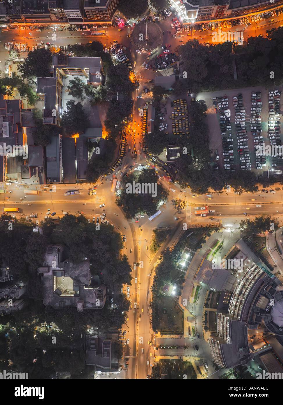 Aerial view of a bustling roundabout with illuminated buildings and ...