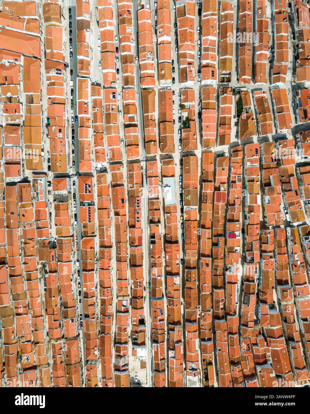 Aerial view of residential rooftops and streets with red roofs in a ...