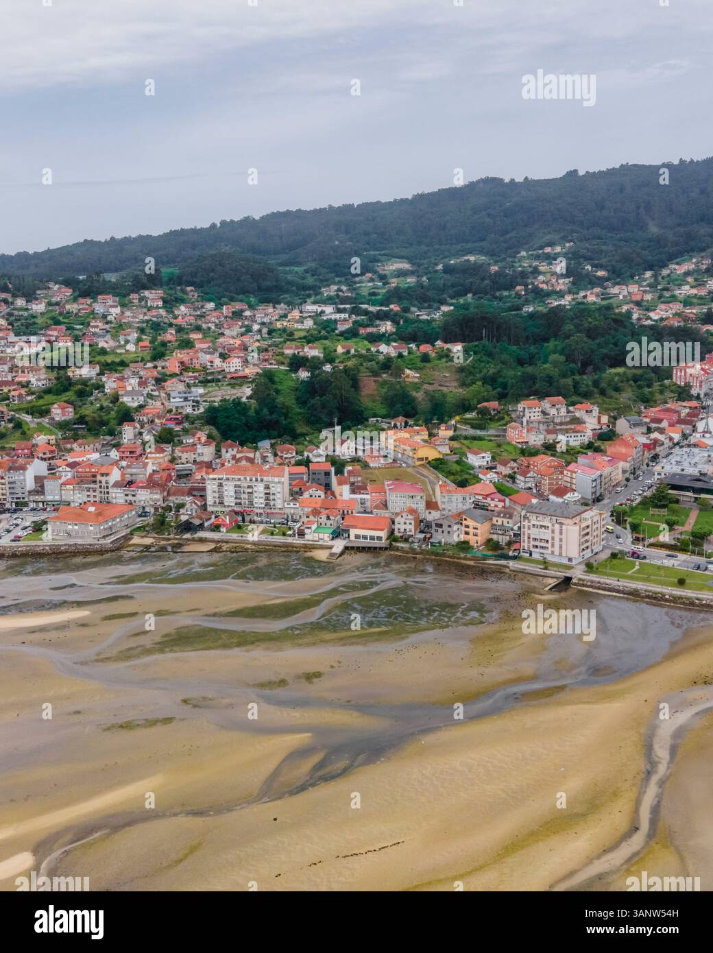 Aerial view of beautiful coastal town with sandy beach and residential ...