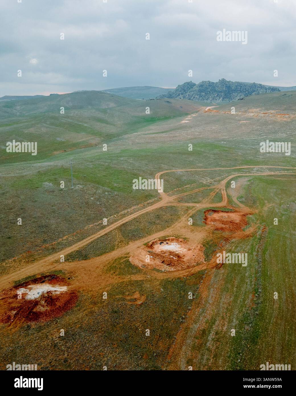 Aerial view of beautiful arid landscape with rugged hills and a winding ...