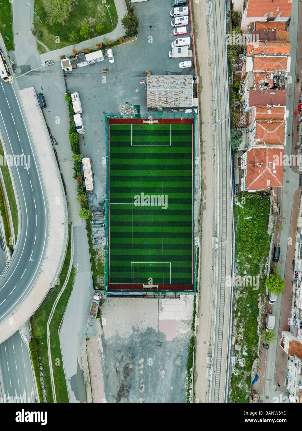 Aerial view of a vibrant football field surrounded by urban buildings ...
