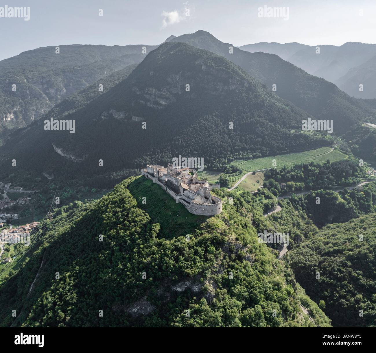 Aerial view of the beautiful Castel Beseno on a hillside surrounded by ...