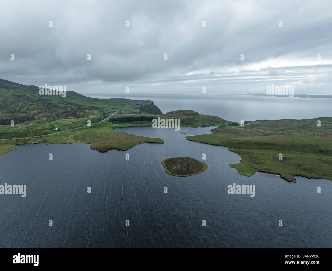 Aerial view of tranquil Loch Leathan surrounded by majestic mountains ...