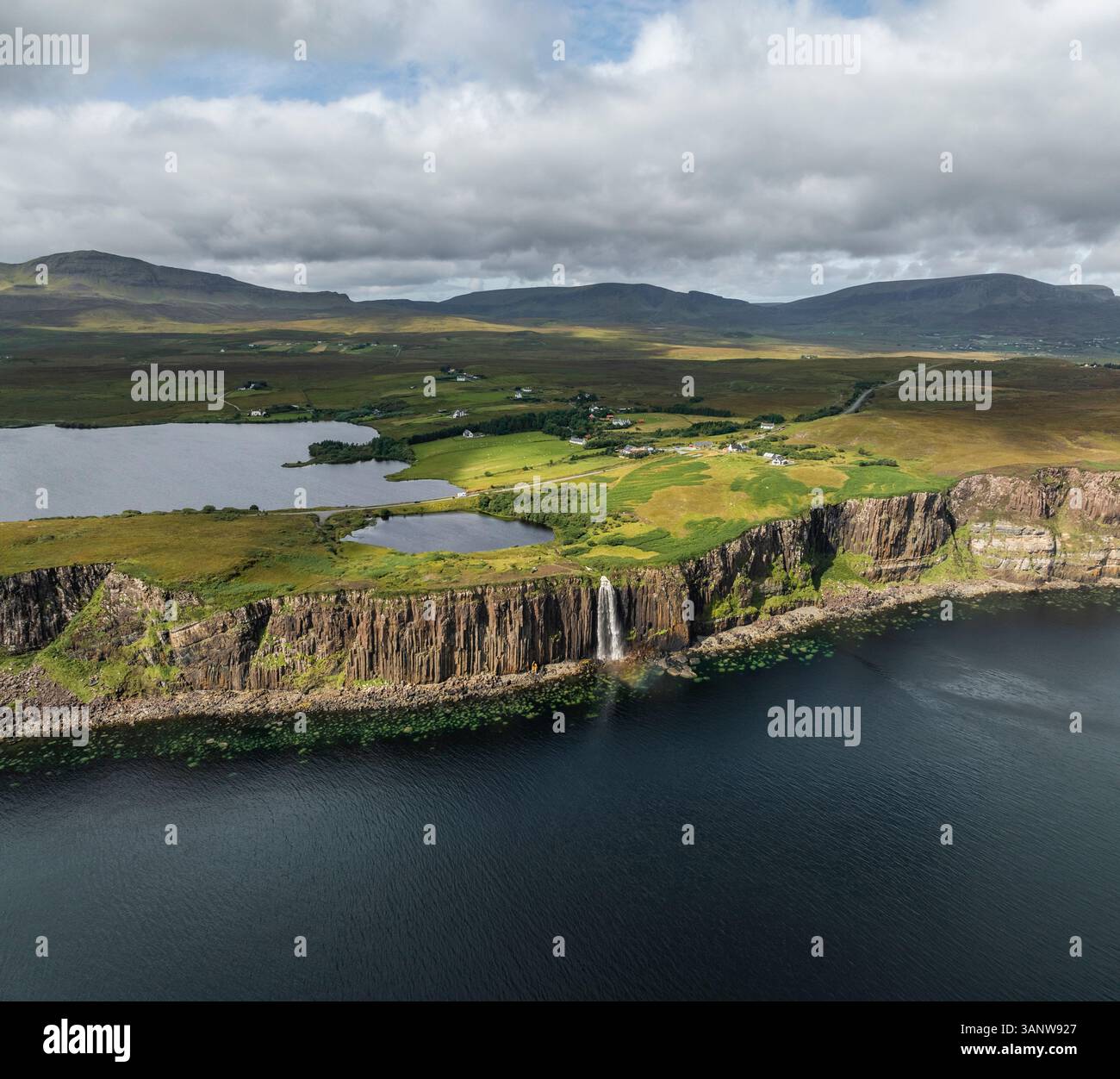 Aerial view of kilt rock waterfall cascading over rugged cliffs into ...