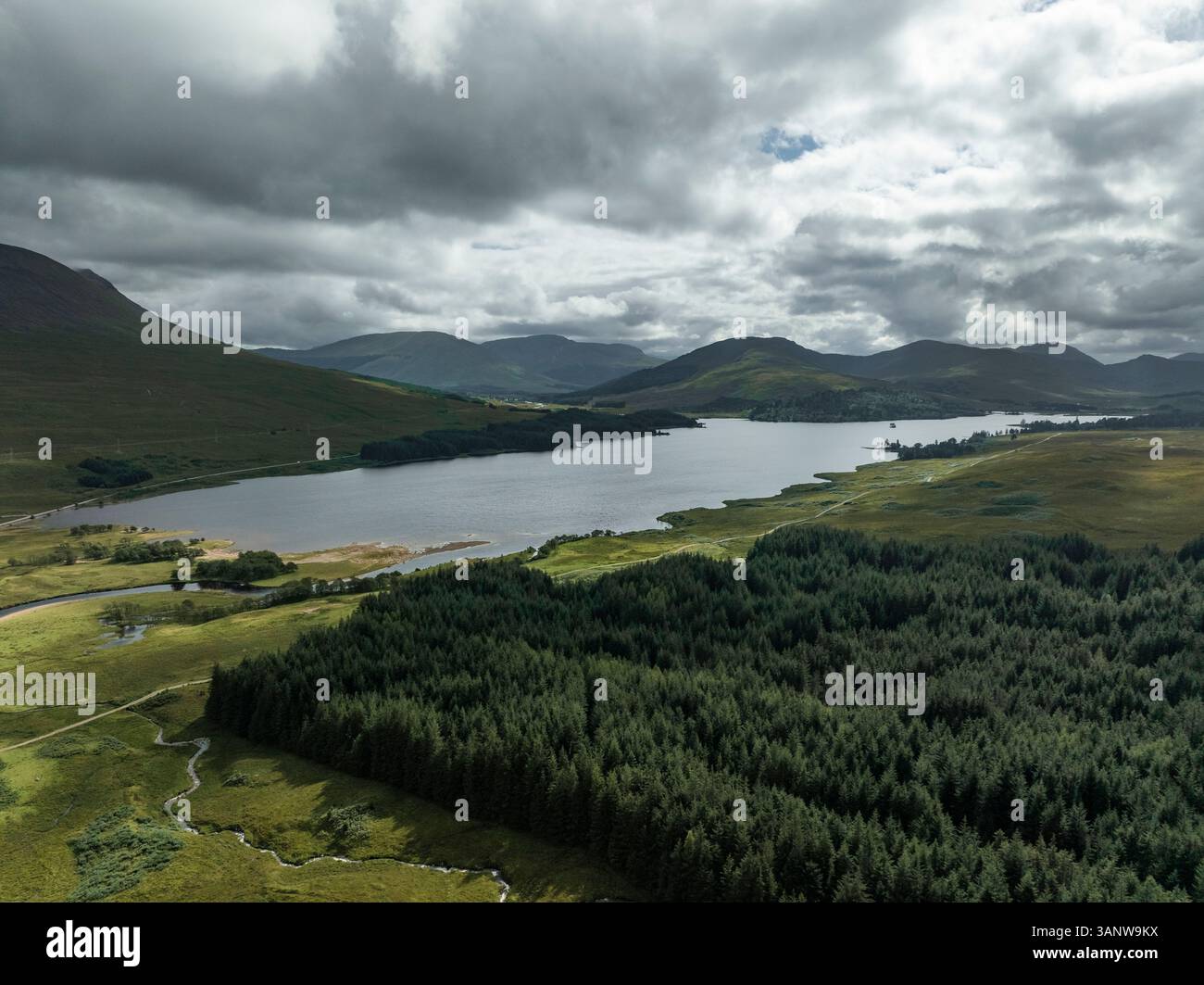 Aerial view of serene Loch Tulla surrounded by majestic mountains and ...