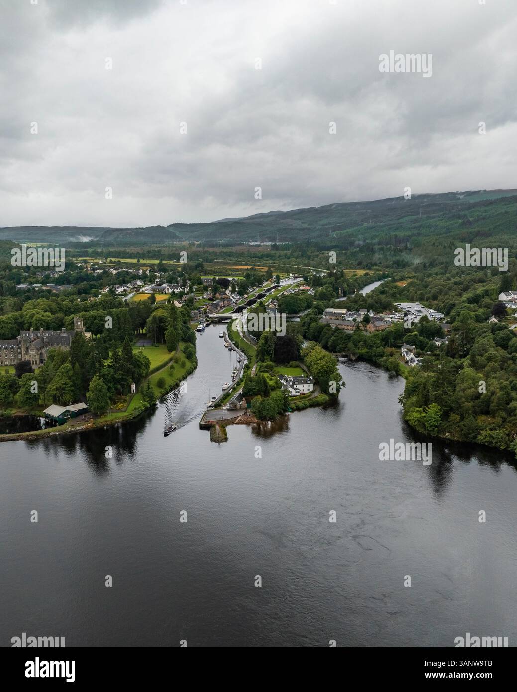 Aerial view of serene Loch Ness surrounded by lush forests and ...