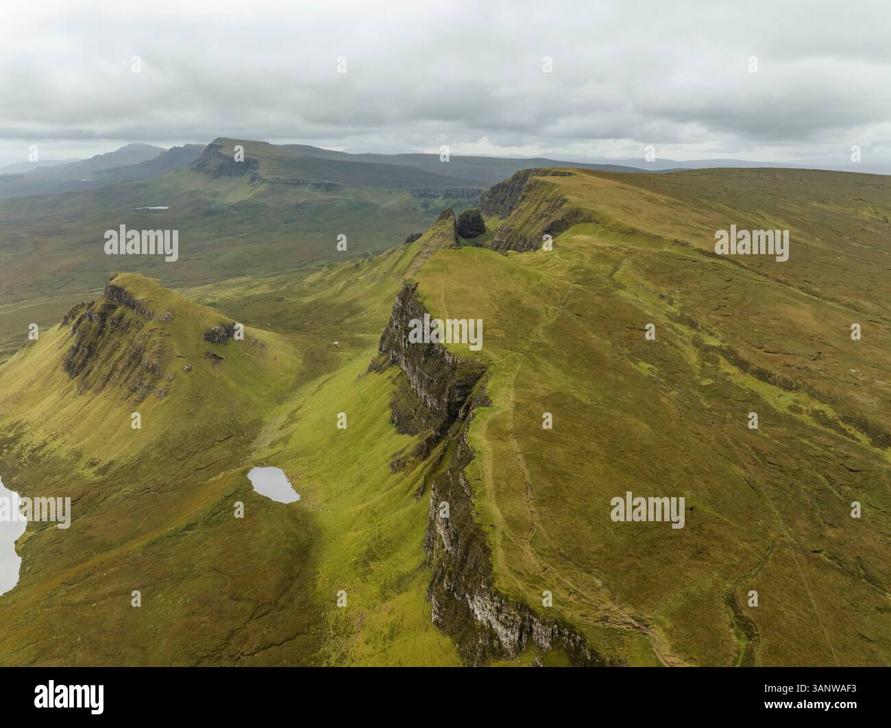 Aerial view of the Quiraing mountain with rugged terrain and grassy ...