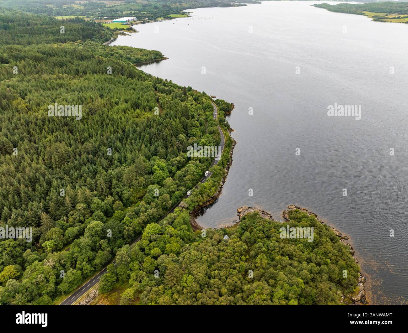 Aerial view of serene Loch Creran surrounded by lush forest and winding ...
