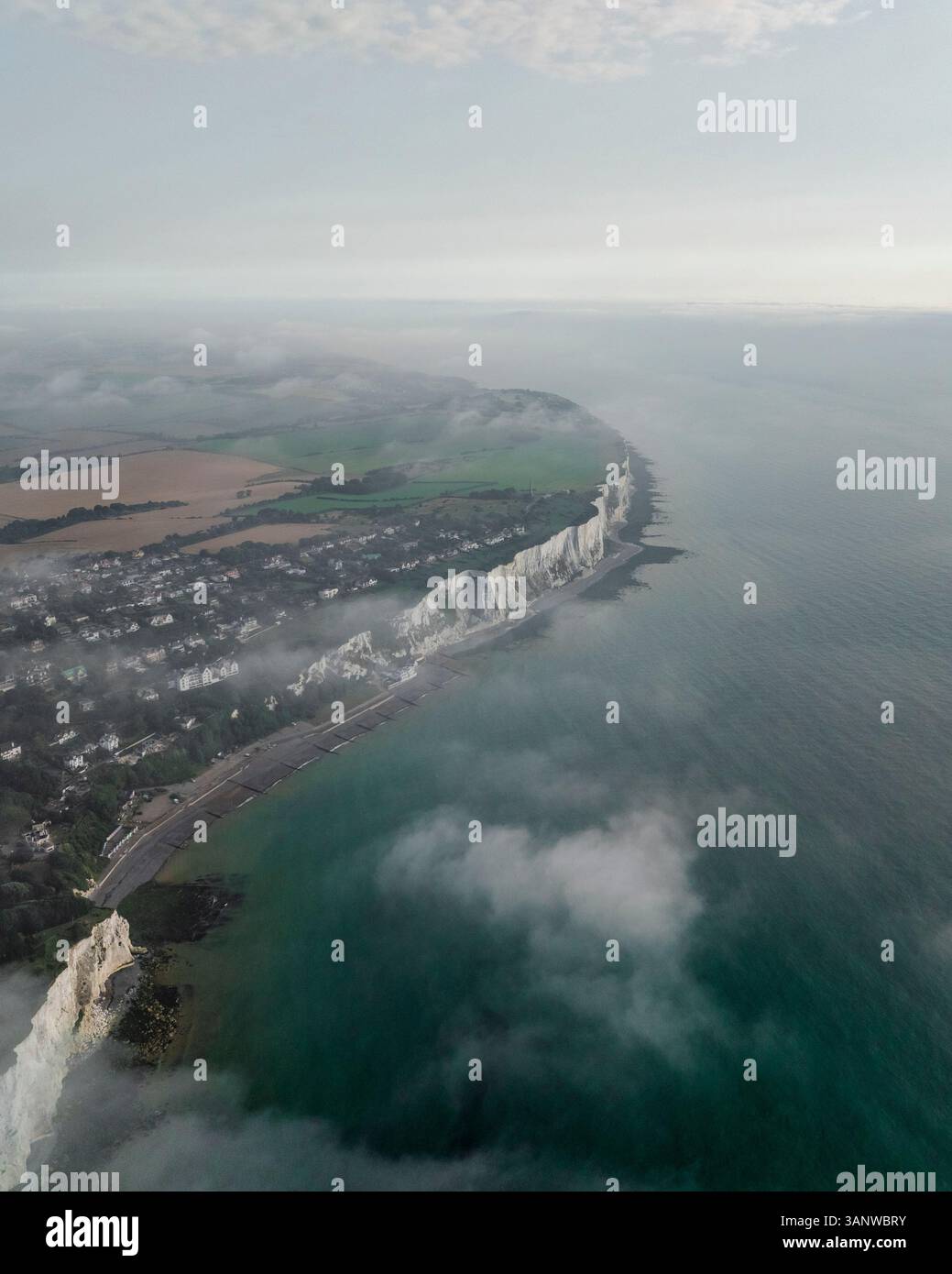 Aerial view of the majestic white cliffs of Dover alongside the serene ...