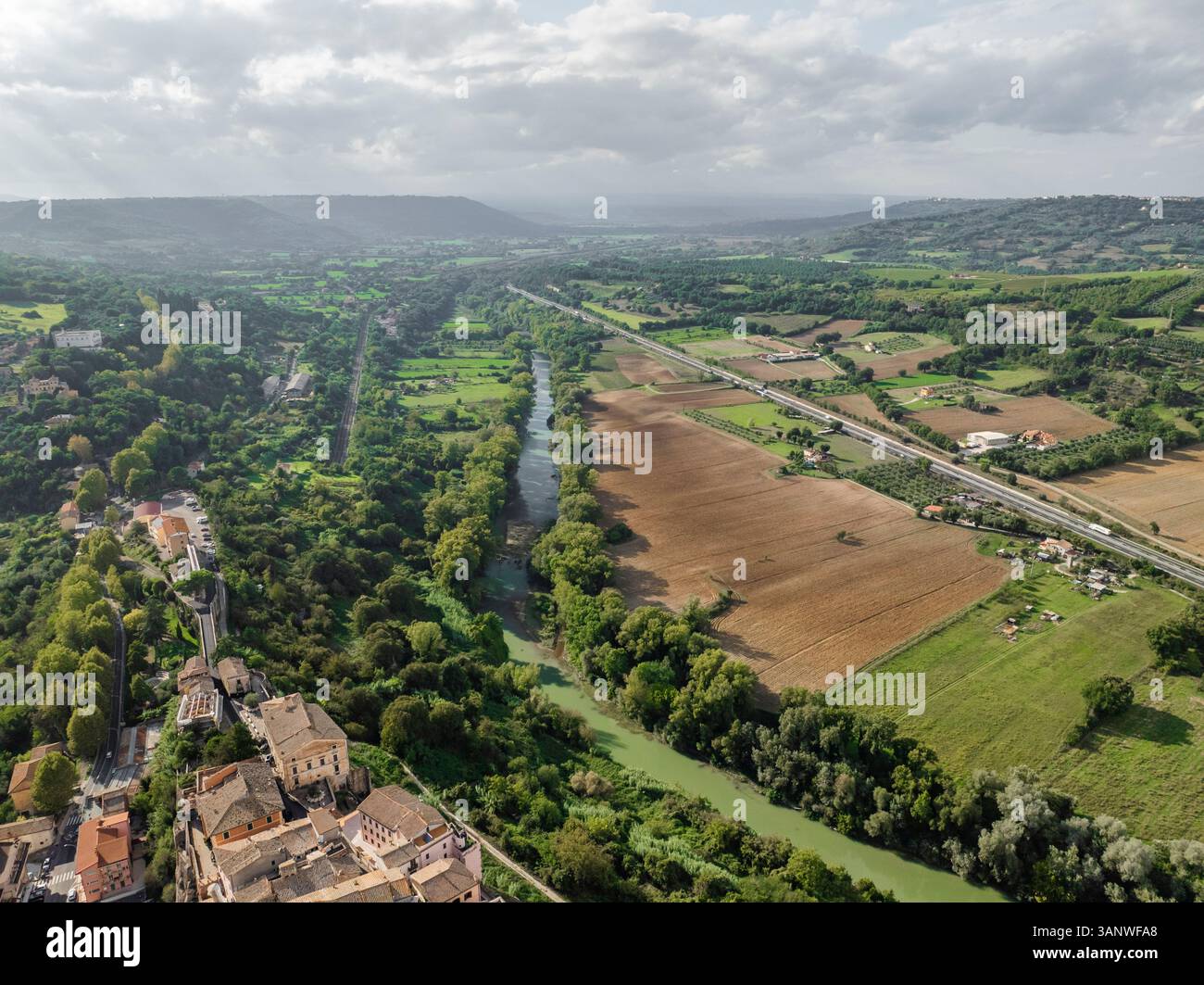 Aerial view of the scenic Tevere river winding through lush fields and ...