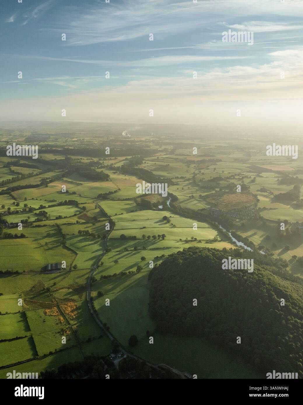 Aerial view of serene hilly countryside with lush green fields and ...
