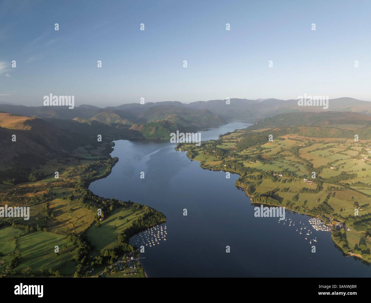 Aerial view of serene Ullswater lake surrounded by beautiful mountains ...