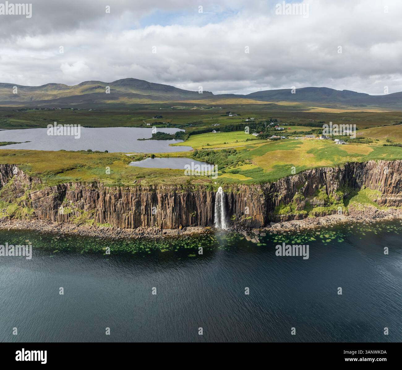 Aerial view of kilt rock waterfall cascading from a dramatic cliff into ...