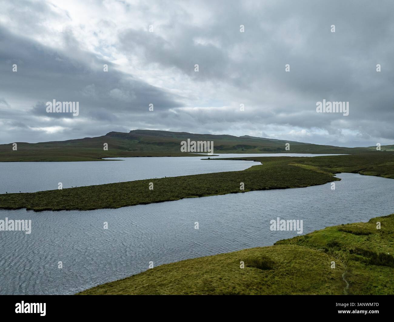 Aerial view of tranquil Loch Leathan surrounded by majestic hills under ...
