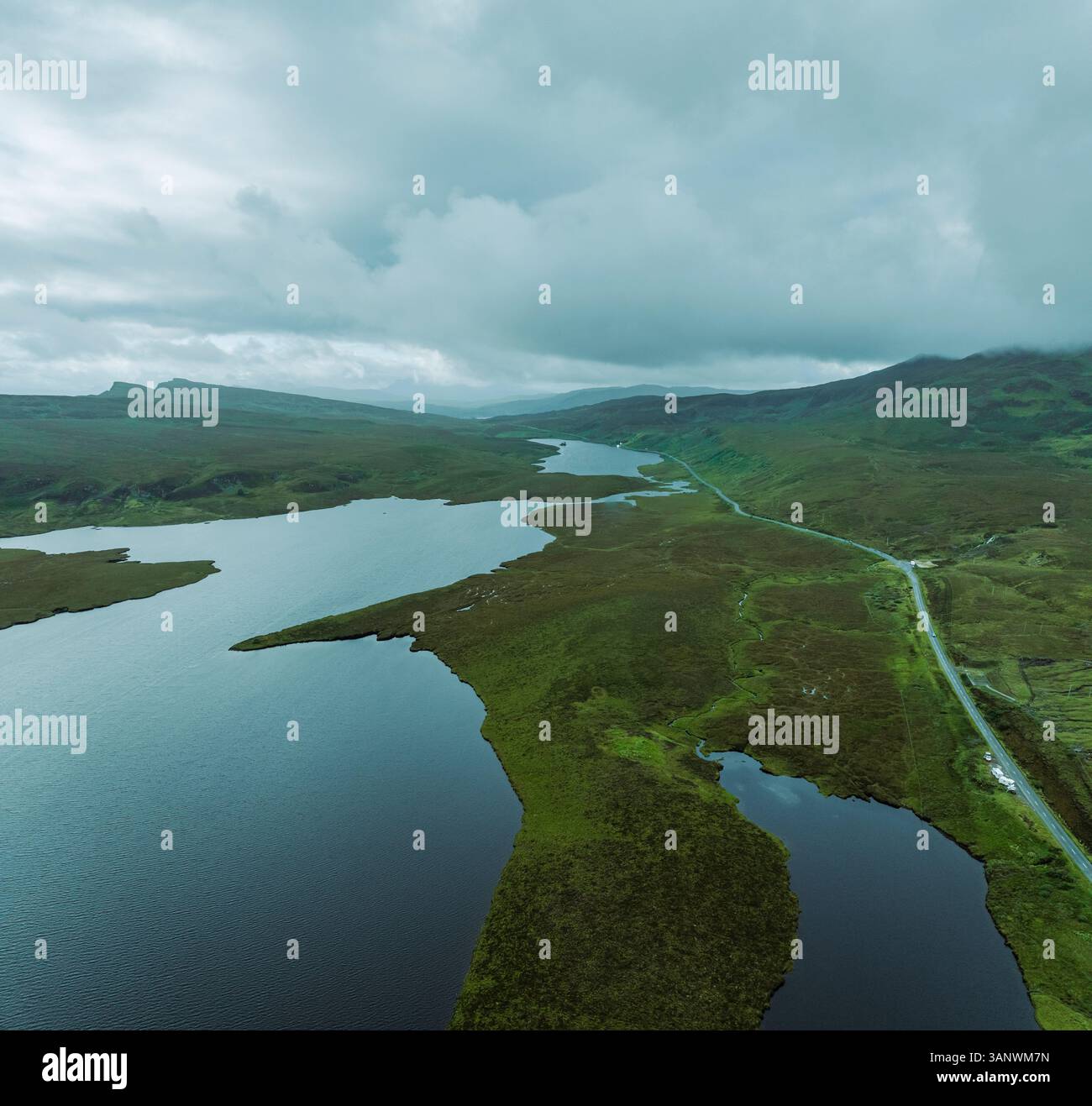 Aerial view of tranquil Loch Leathan surrounded by majestic mountains ...