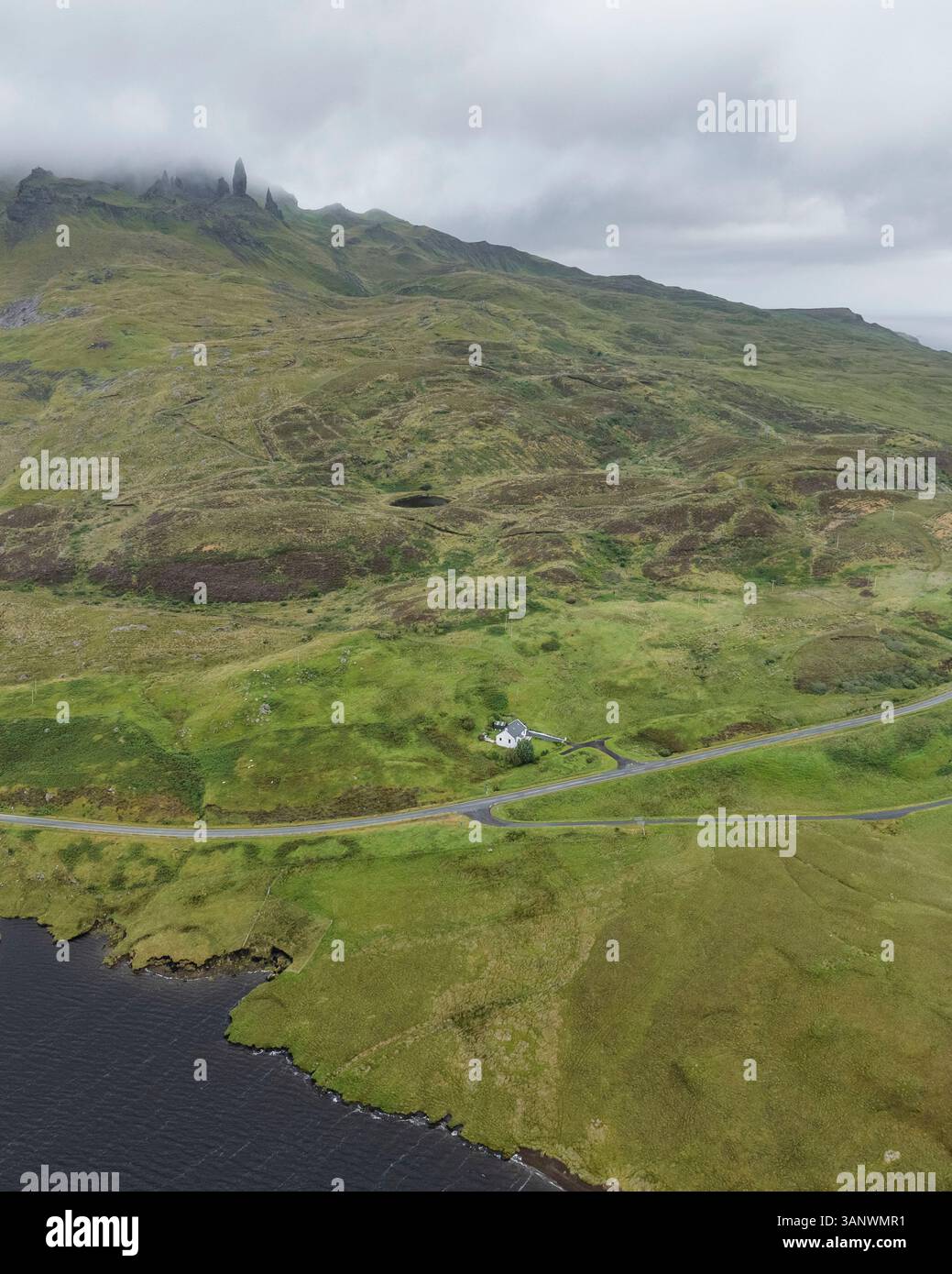 Aerial view of Loch Leathan surrounded by majestic mountains and lush ...