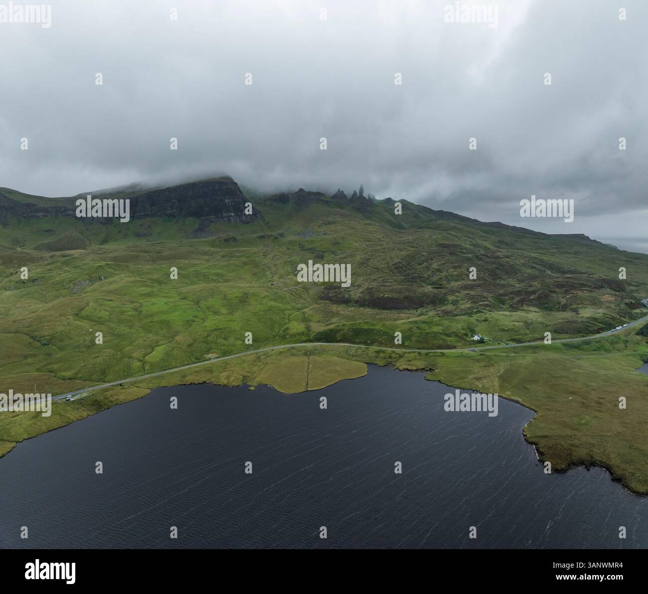 Aerial view of Loch Leathan surrounded by rugged mountains and a ...
