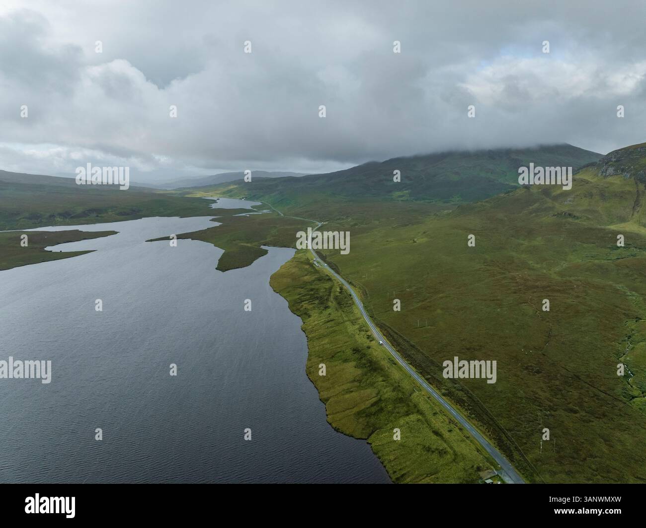 Aerial view of serene Loch Leathan surrounded by majestic mountains and ...