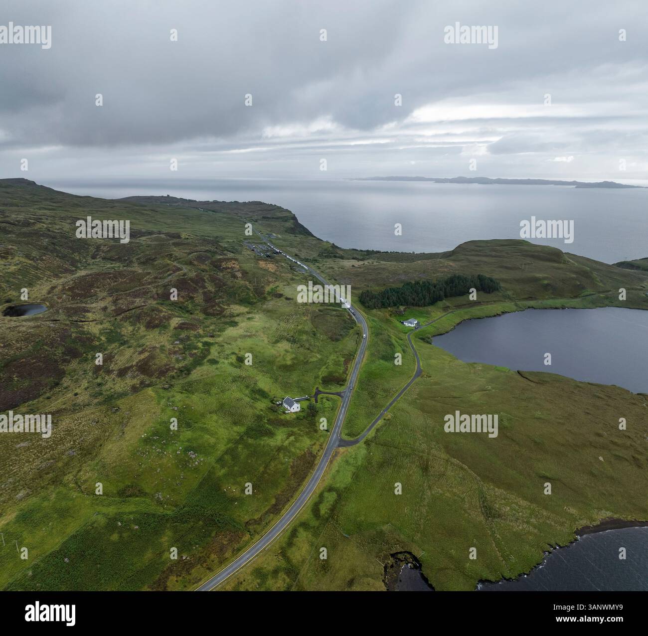 Aerial view of tranquil Loch Leathan surrounded by lush hills and a ...