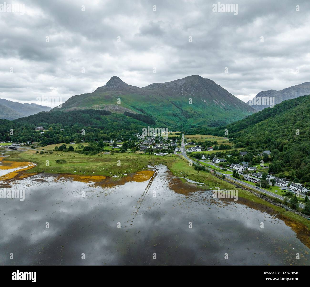 Aerial view of tranquil Loch Leven surrounded by majestic mountains and ...