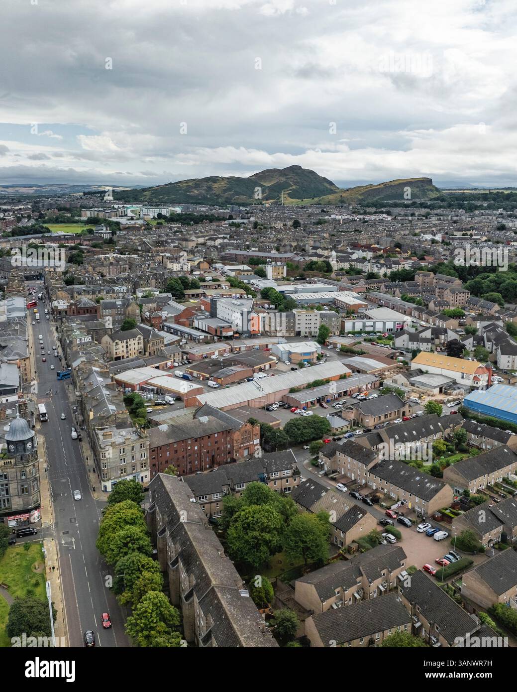 Aerial view of arthur seat volcano surrounded by urban architecture and ...