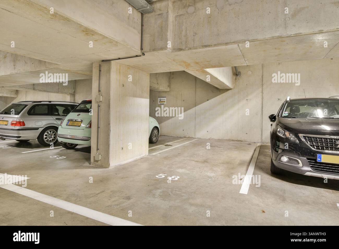A clean, well-lit modern underground parking garage showcasing ...