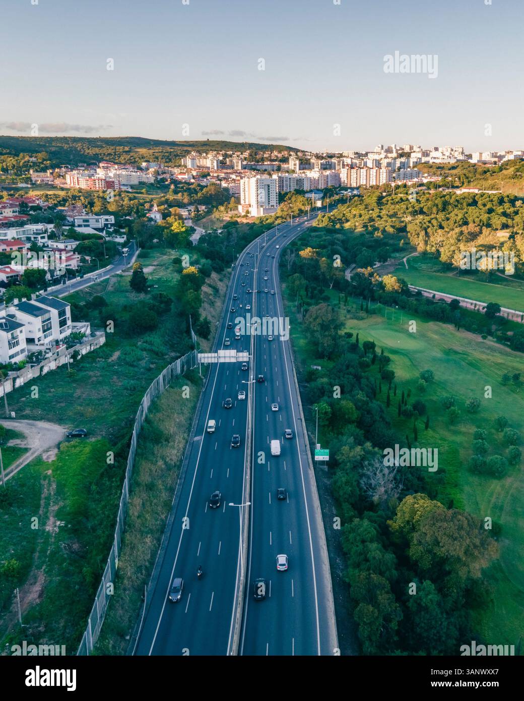 Aerial view of vehicles driving on a busy highway in nature during a ...