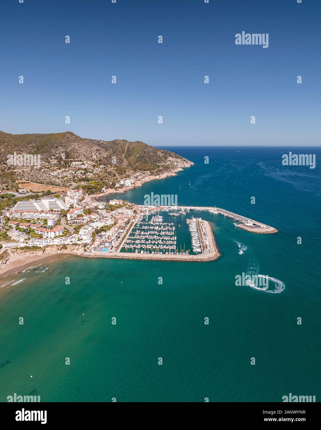 Aerial view of Sitges seaside town with Mediterranean Sea, boat, and ...