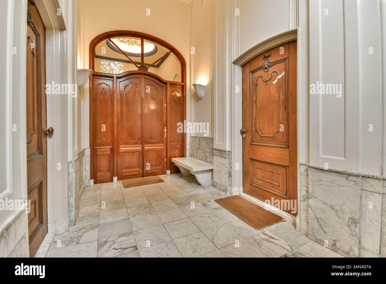 Stylish interior featuring wooden doors and marble flooring, showcasing ...