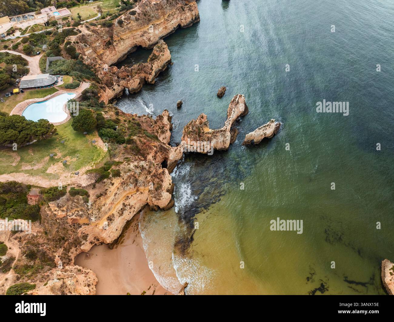 Aerial view of sandy beach and cliffs along Praia dos Tres Irmaos ...
