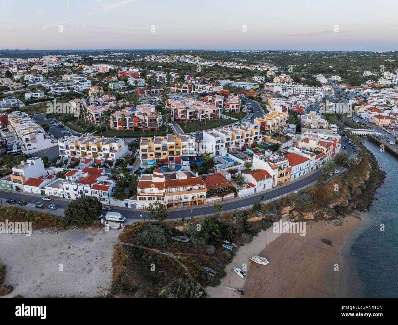 Aerial view of Ferragudo town with beautiful beach and boats on Arade ...