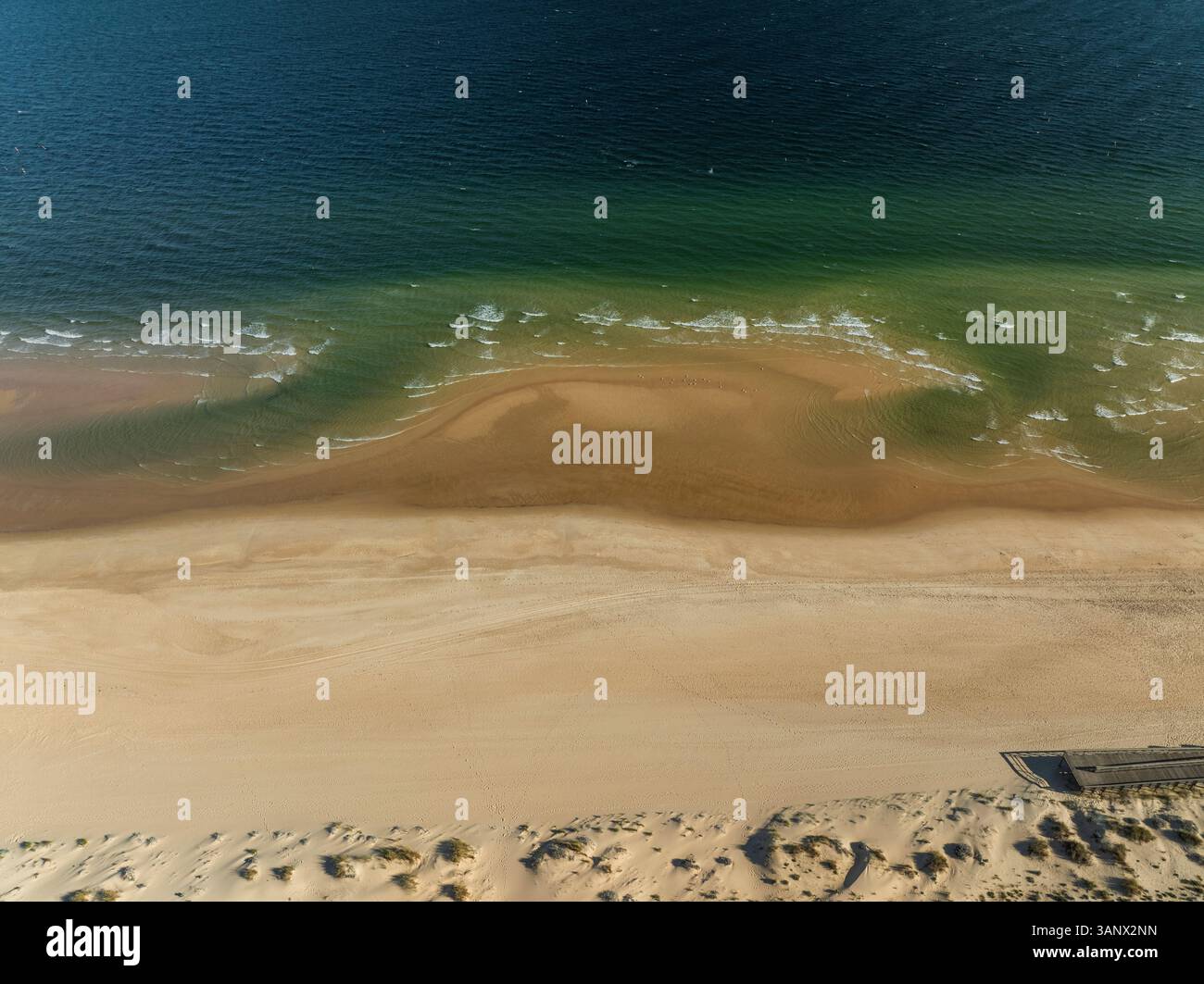 Aerial view of sandy beach along the coast of Altura, Algarve region ...