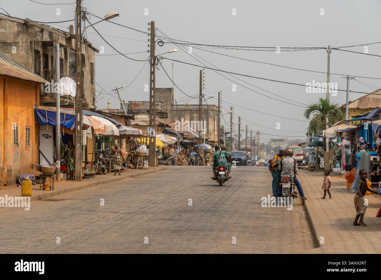 The capital of Benin, Porto-Novo, with poor streets and market stalls ...