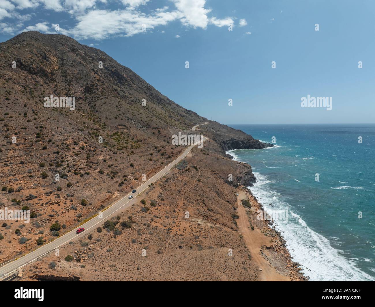 Aerial view of desert landscape with sand dunes and road, Cabo de Gata ...
