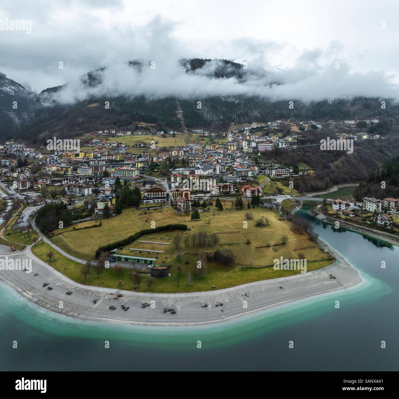 Aerial view of Molveno Lake with foggy Dolomites, Molveno, Trentino ...