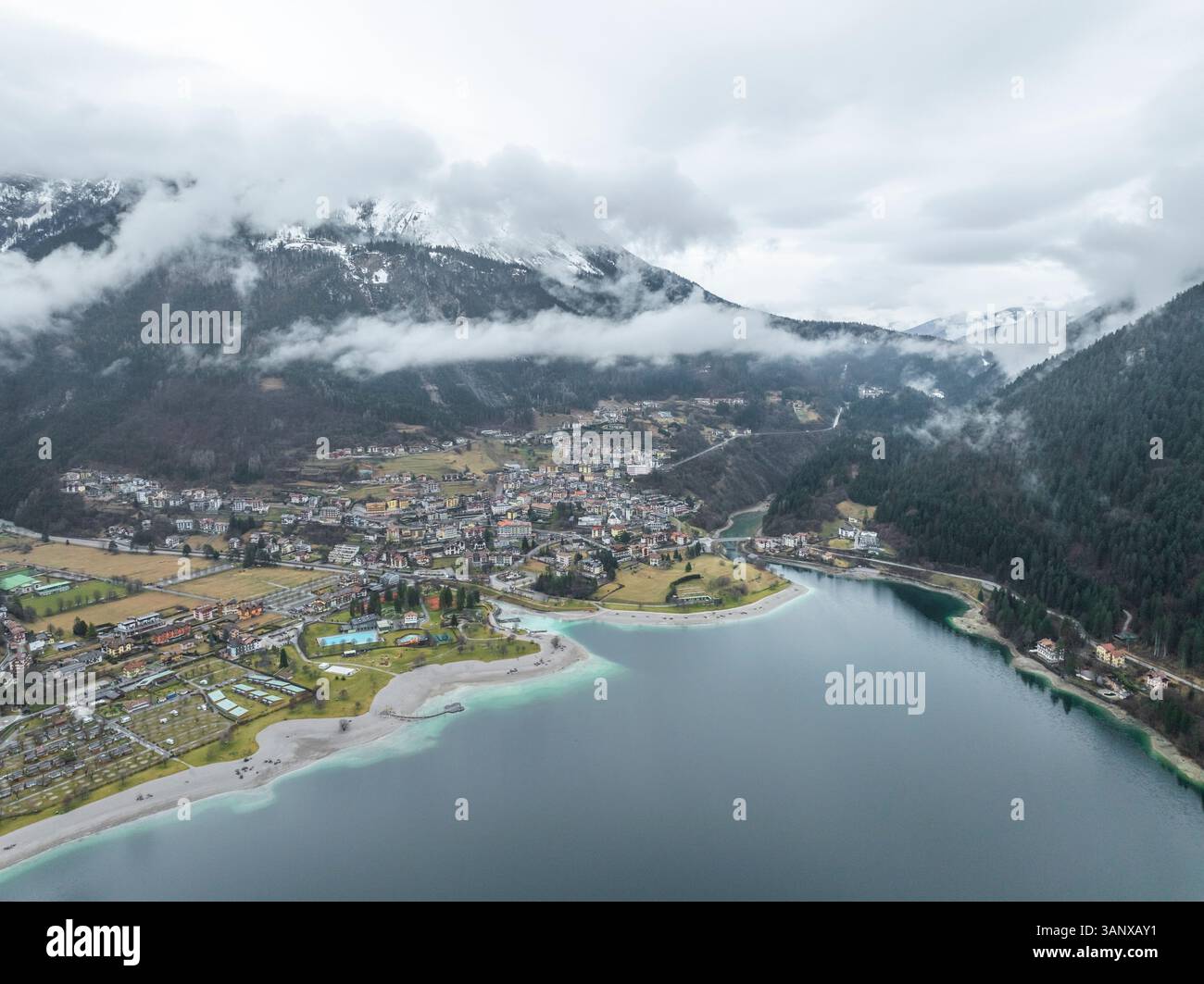 Aerial view of Molveno lake in winter with foggy dolomites, Trentino ...